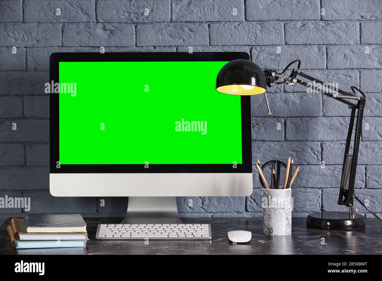 Computer display with chroma key on desk in room. Comfortable workplace ...