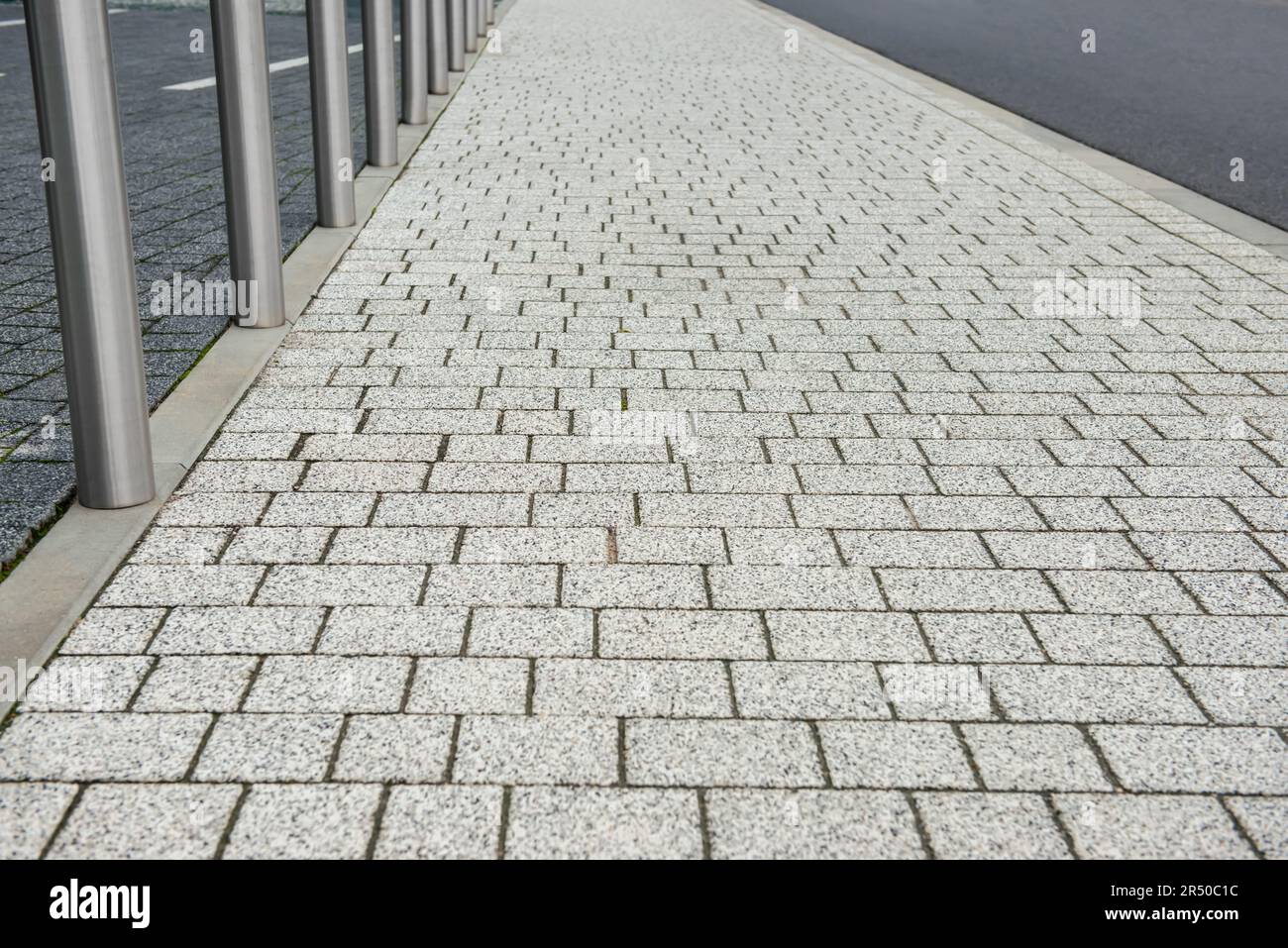 Stone sidewalk path near road on city street. Footpath covering Stock ...