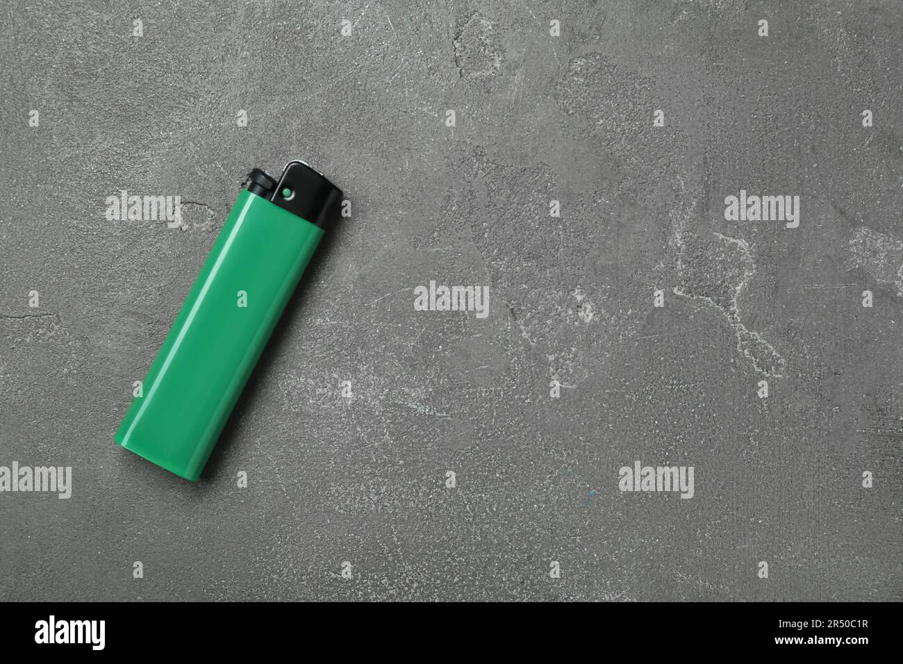 Stylish small pocket lighter on grey table, top view. Space for text ...