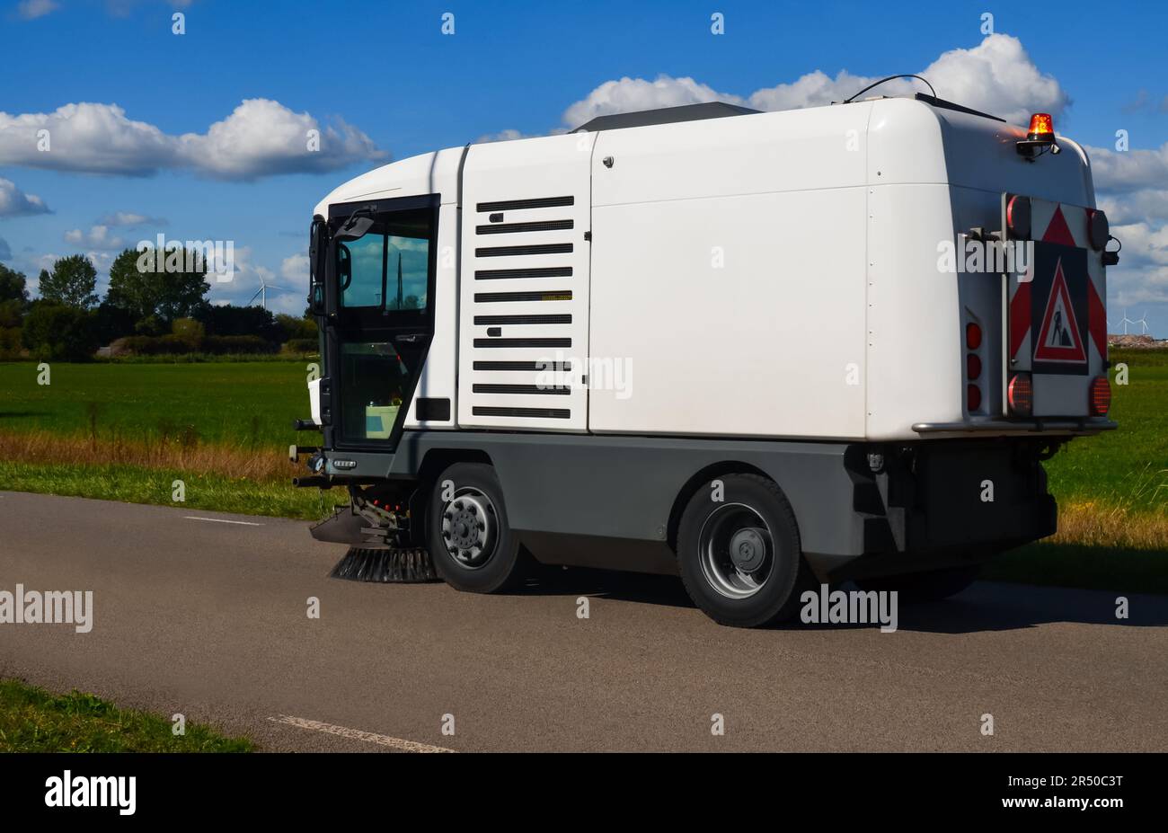 Sweeping car on asphalt road in autumn Stock Photo - Alamy