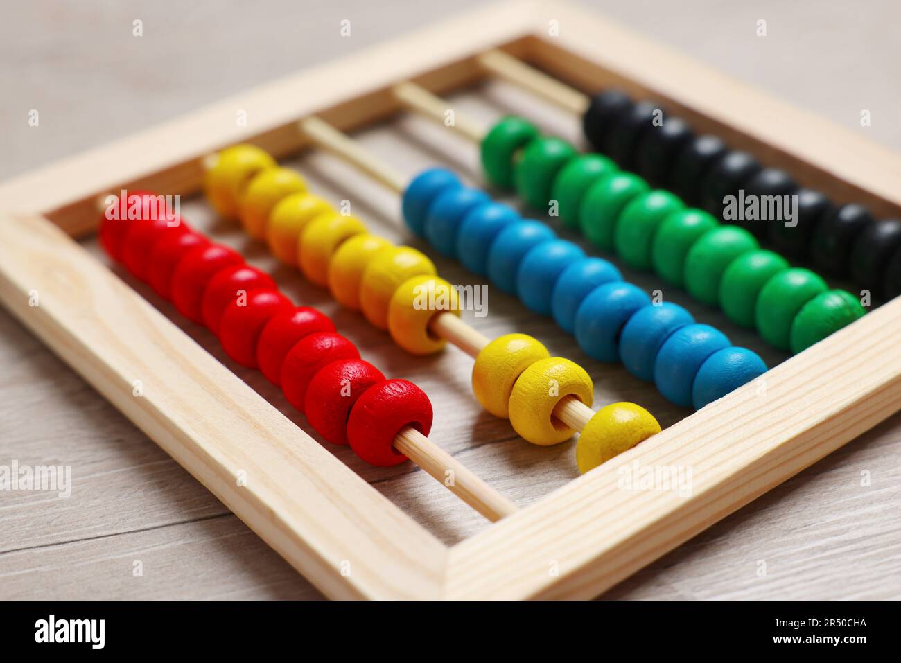 Colorful toy abacus on white wooden table, closeup. Funny math game ...