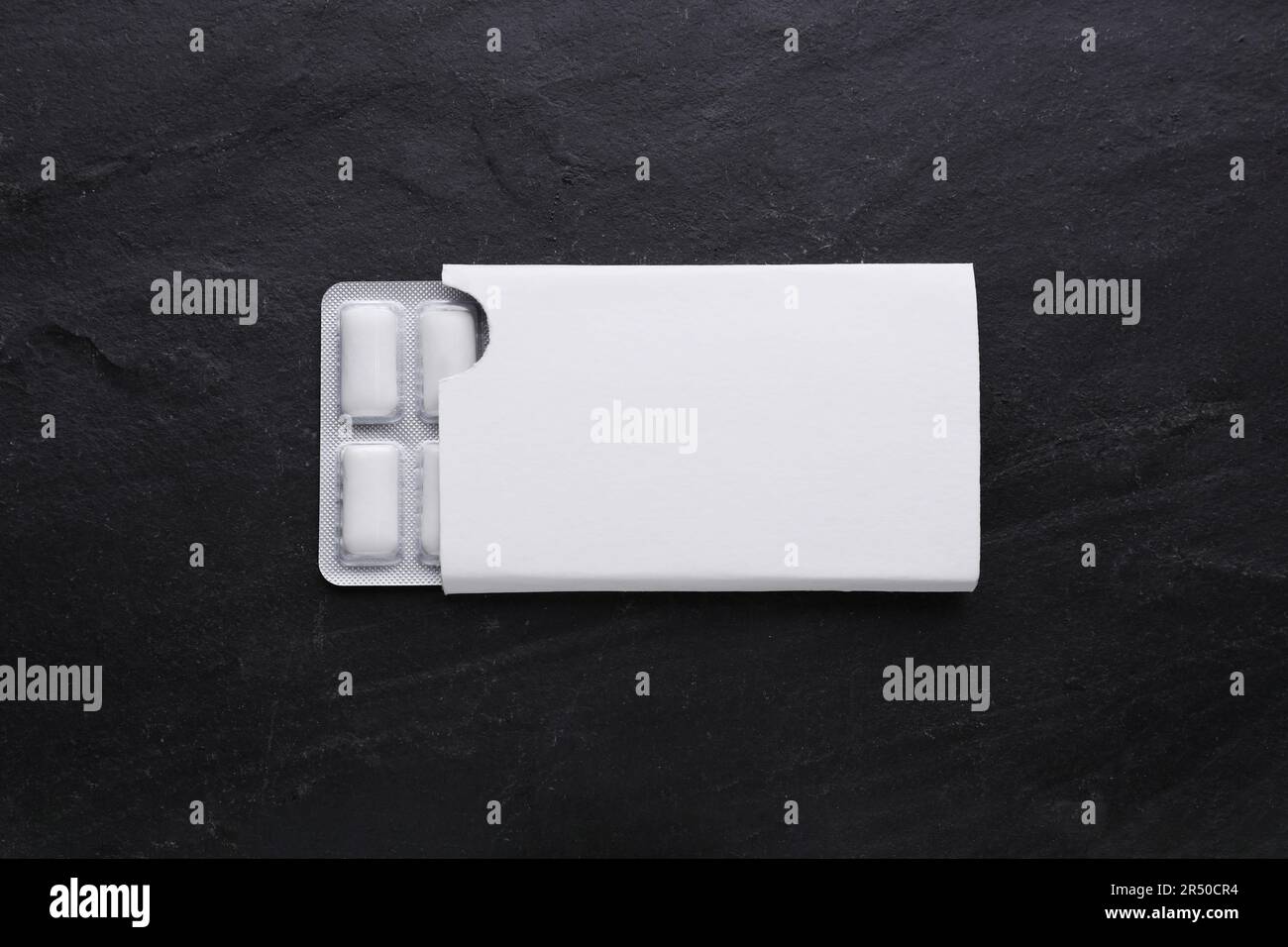 Blister with chewing gums on black table, top view Stock Photo - Alamy