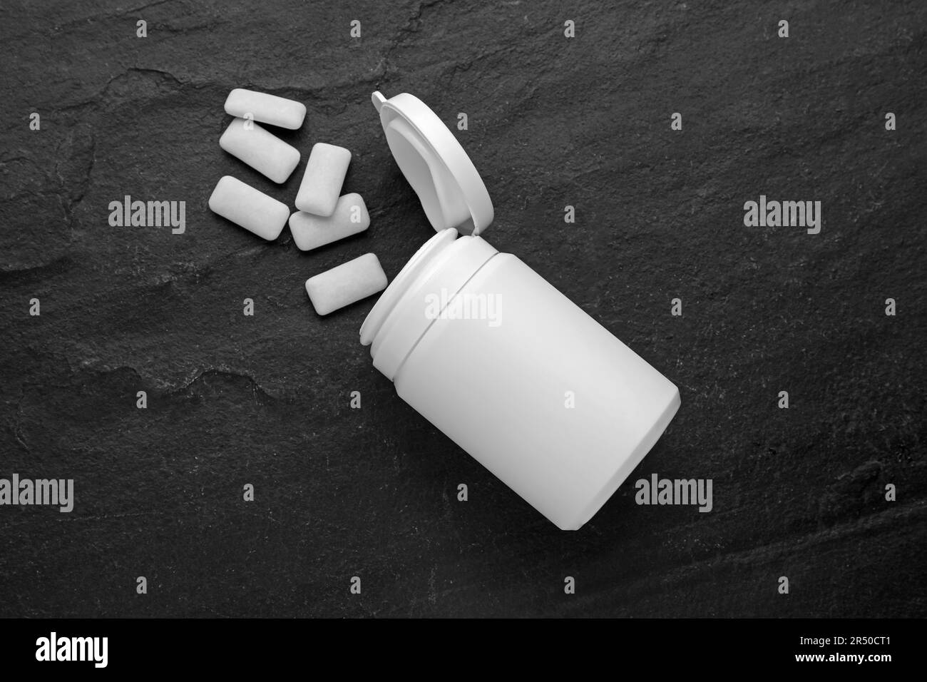Jar with chewing gums on black table, flat lay Stock Photo - Alamy
