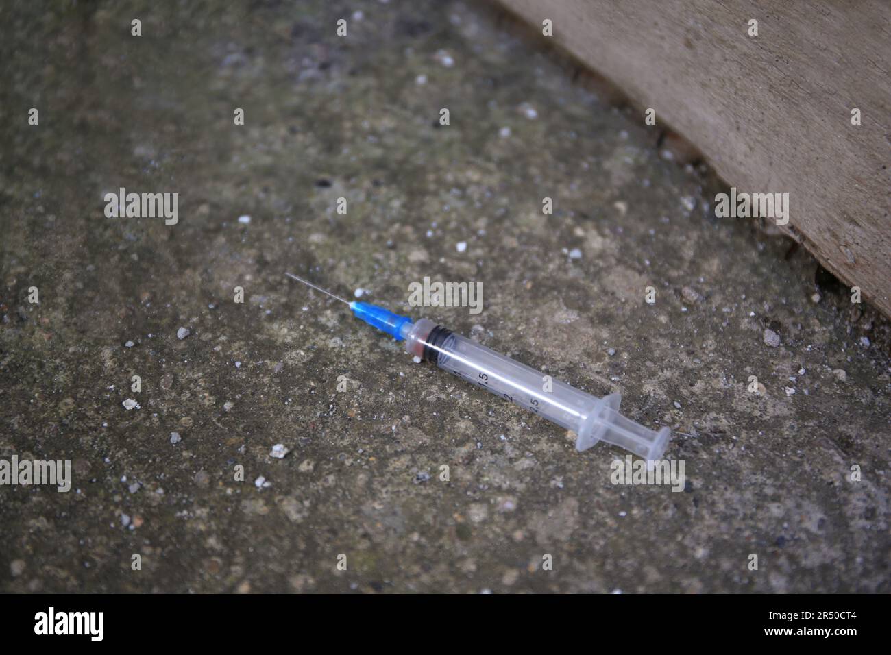 Disposable syringe with needle on concrete surface outdoors Stock Photo ...