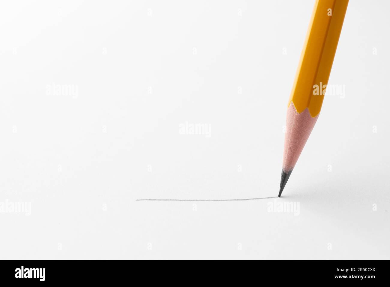 Drawing with sharp graphite pencil on white sheet of paper, closeup ...