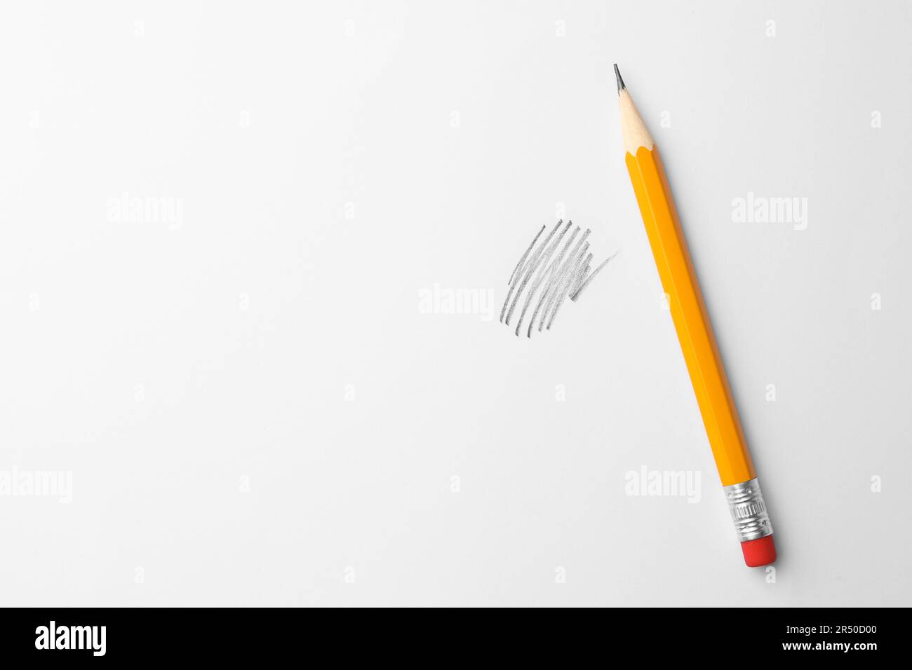 Sharp graphite pencil with eraser and hand drawn scribble on white ...