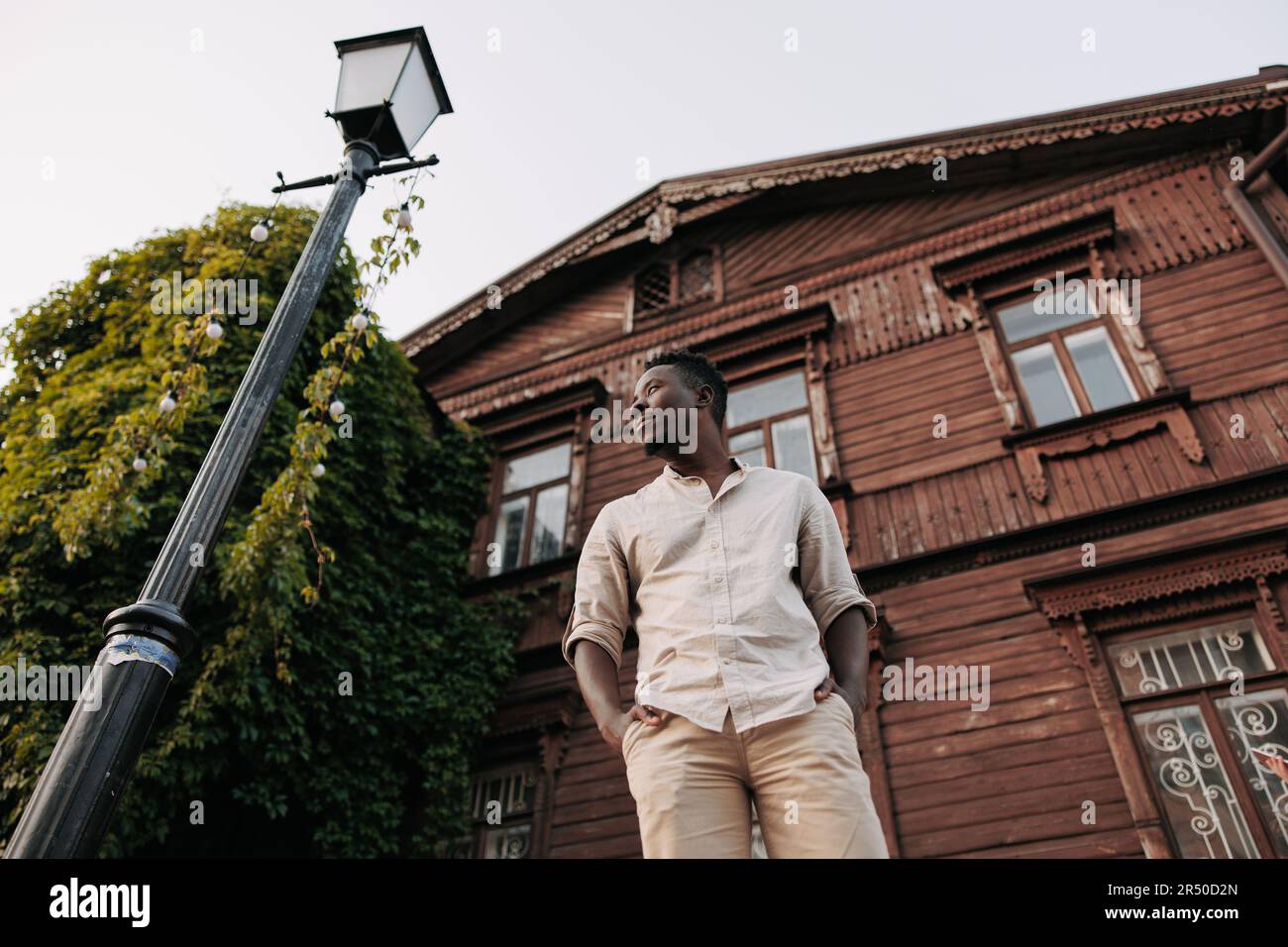 Young waiting african man is standing on street in city against of ...