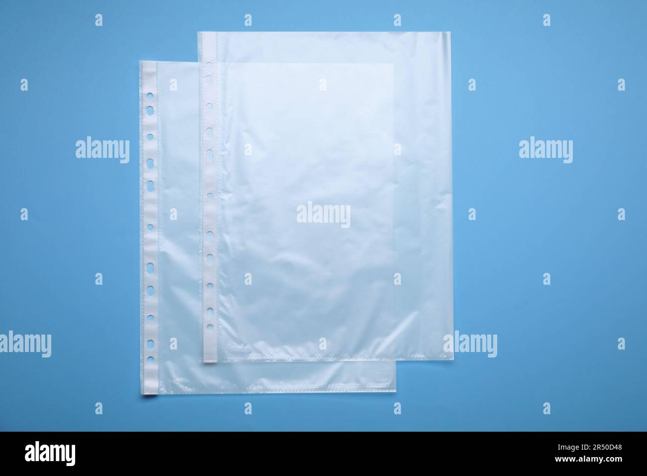 Punched pockets on light blue background, flat lay Stock Photo - Alamy