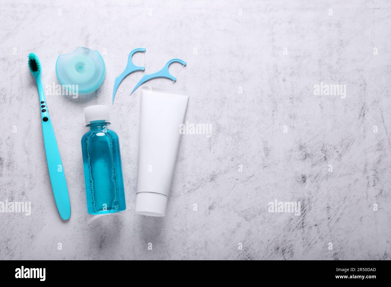 Flat lay composition with dental floss and different teeth care ...