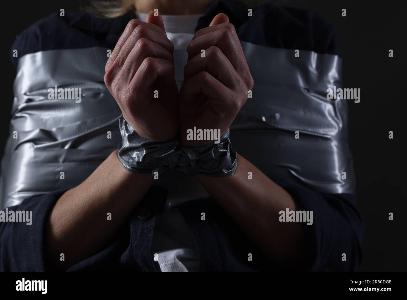 Woman taped up and taken hostage on dark background, closeup Stock ...