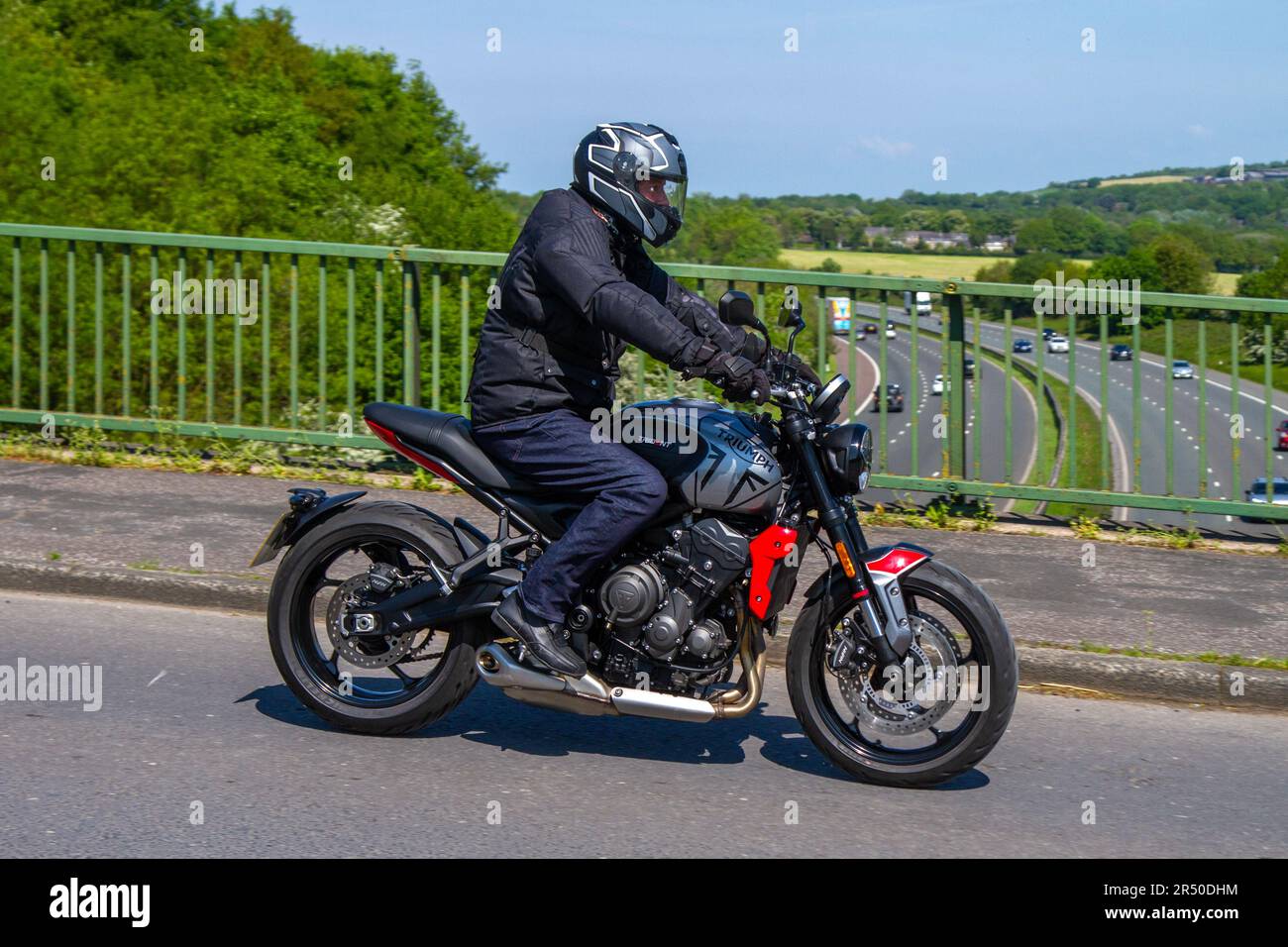 2022 Silver Triumph Trident 660 cc motorcycle crossing motorway bridge ...