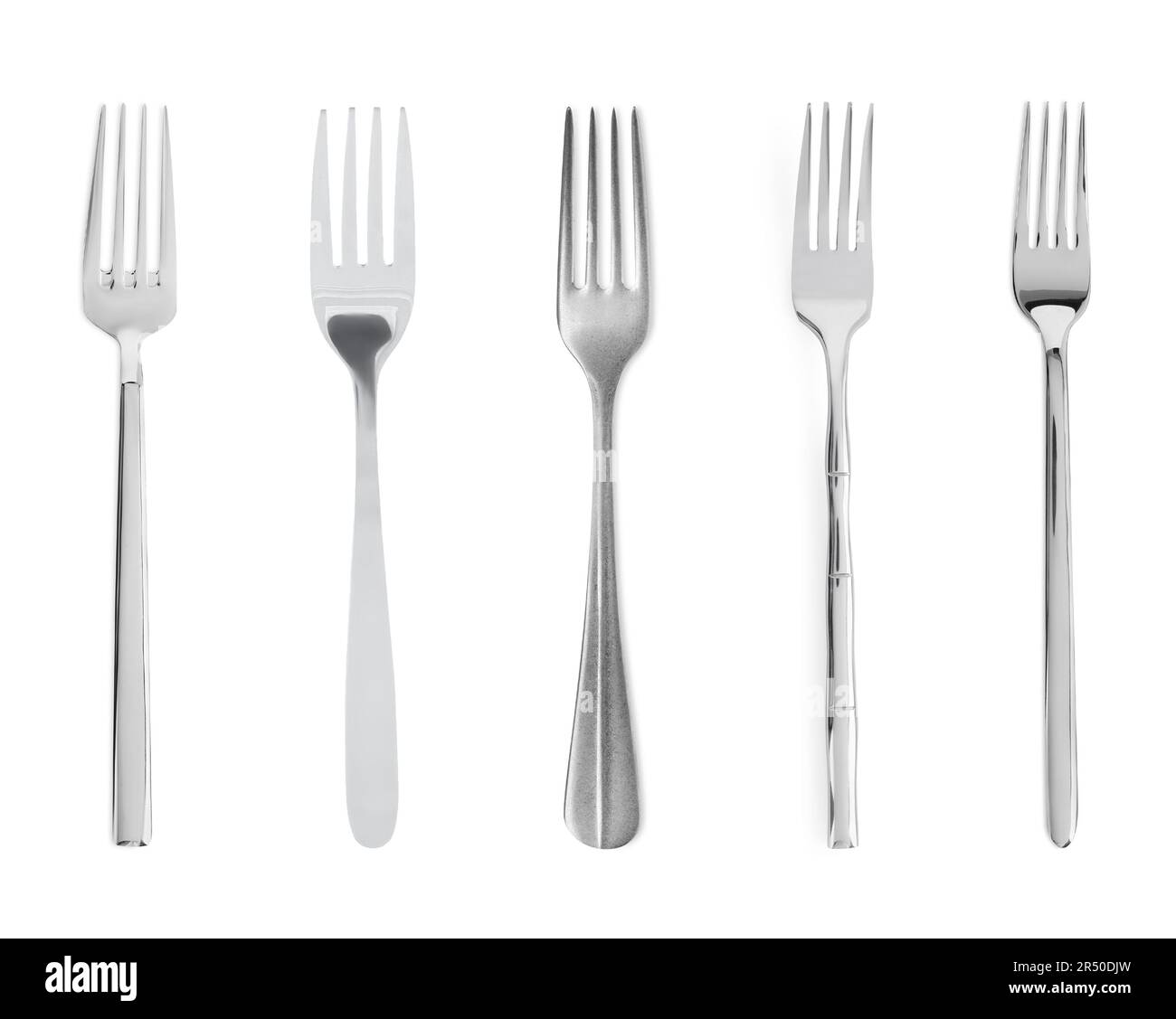 Set of shiny metal forks on white background Stock Photo - Alamy