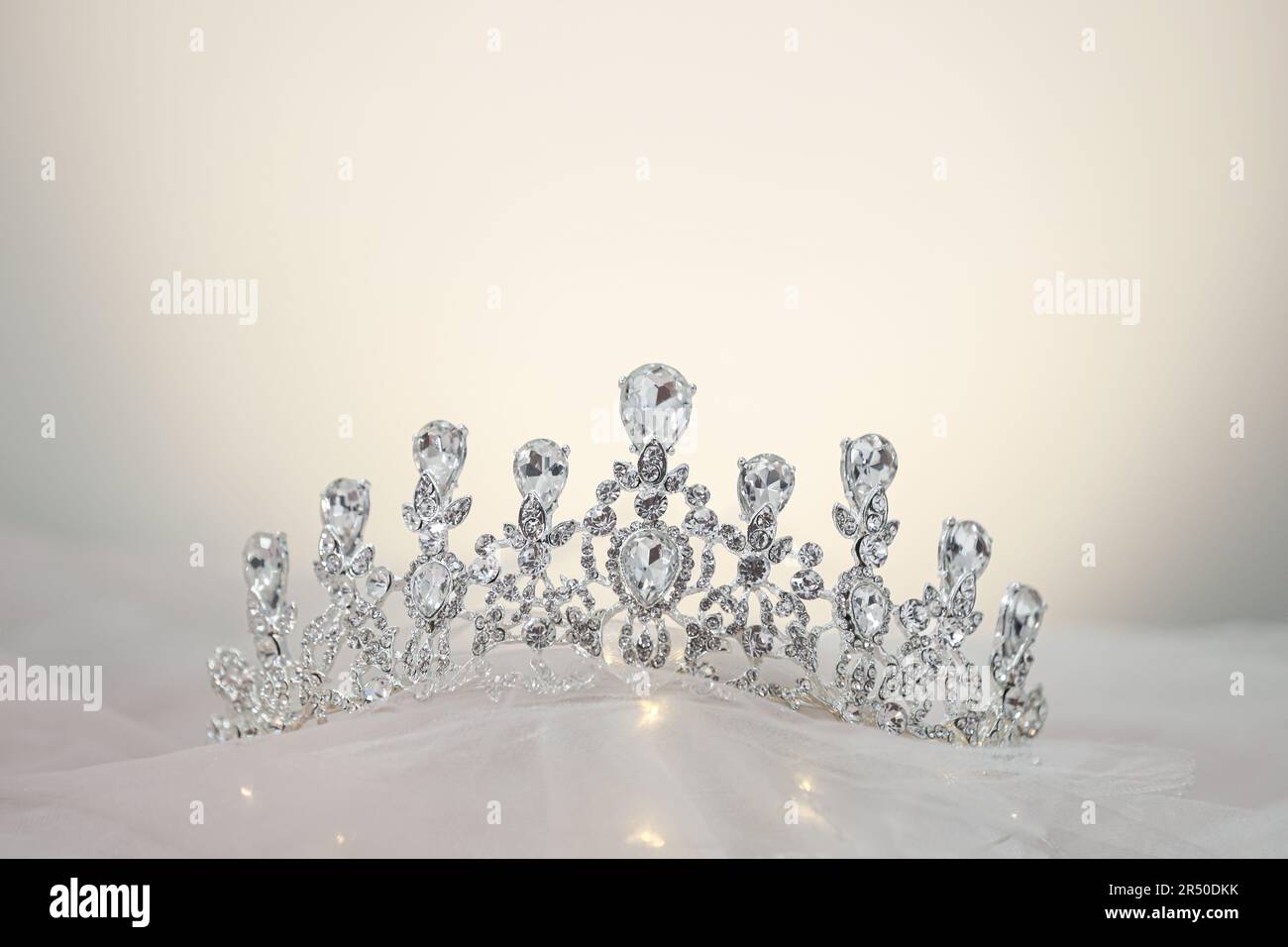Beautiful silver tiara with diamonds on light cloth Stock Photo - Alamy