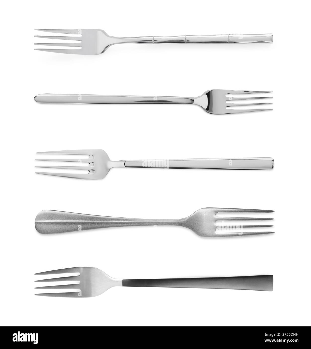 Set of shiny metal forks on white background Stock Photo - Alamy