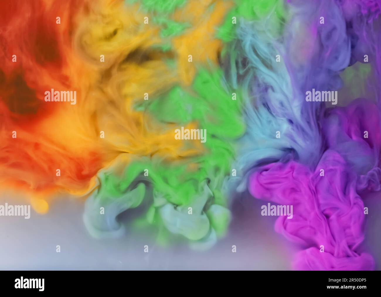 Splash of rainbow colors inks on grey background Stock Photo - Alamy