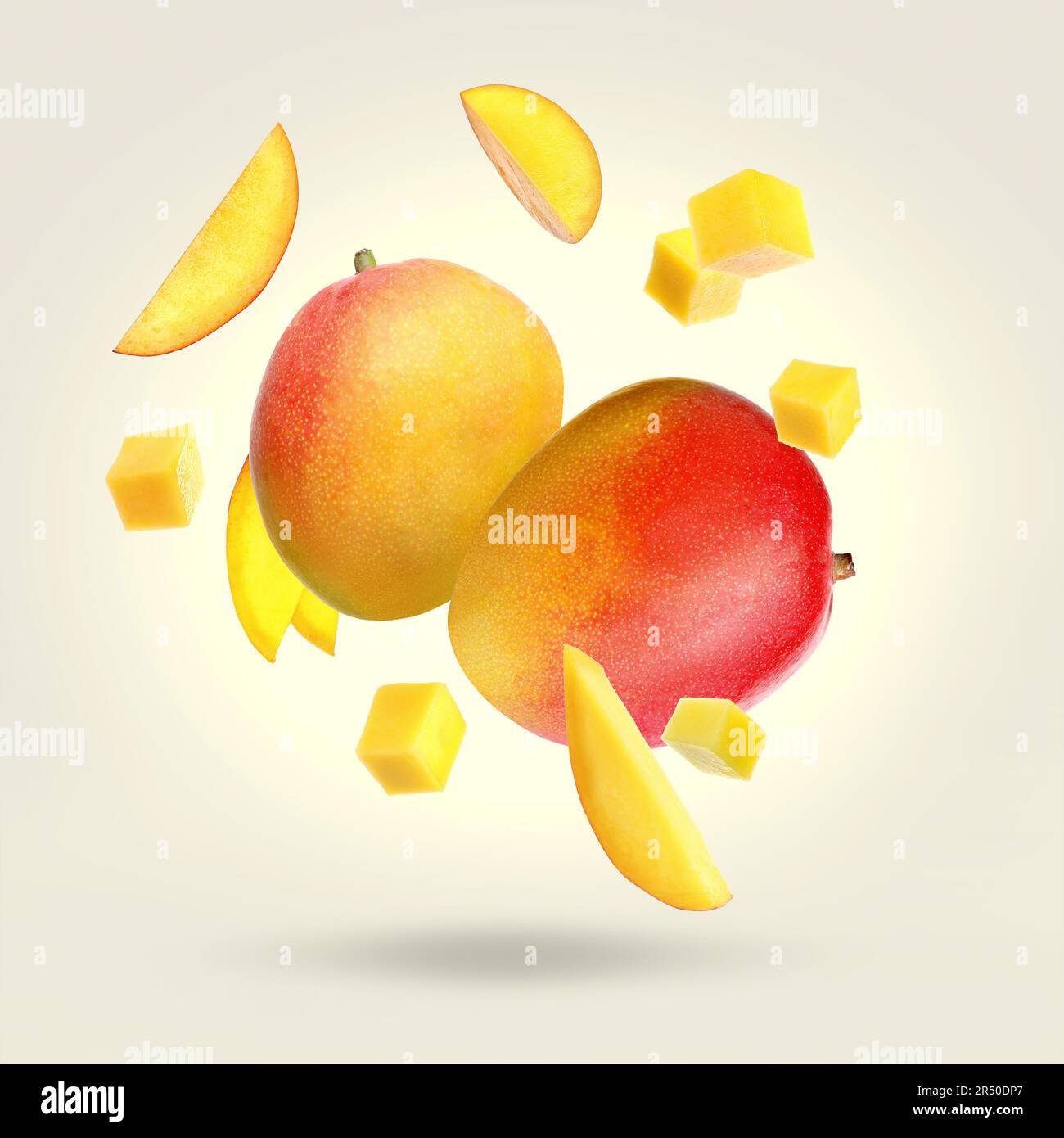 Delicious mango fruits falling on white background Stock Photo - Alamy