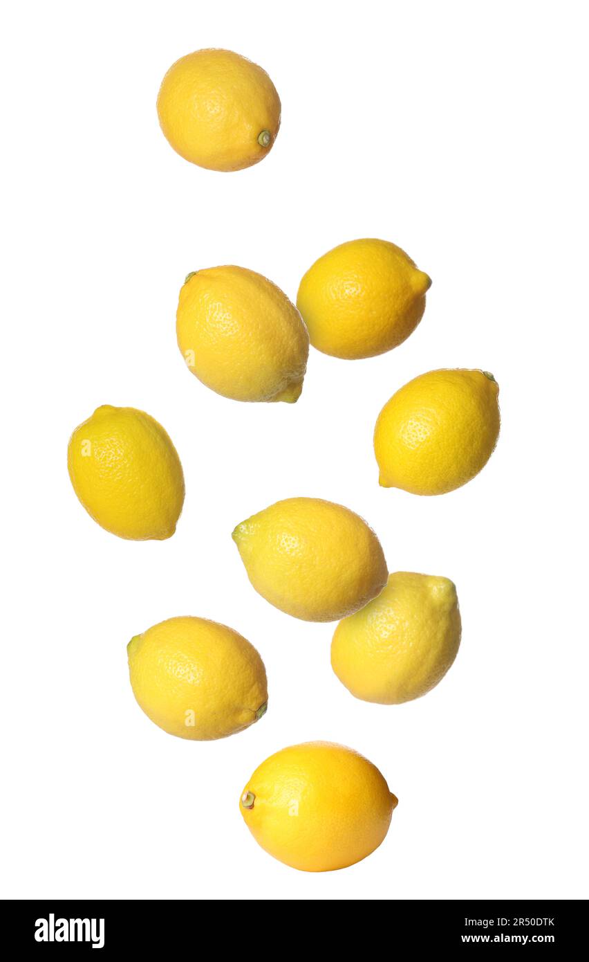 Fresh ripe lemons falling on white background Stock Photo - Alamy
