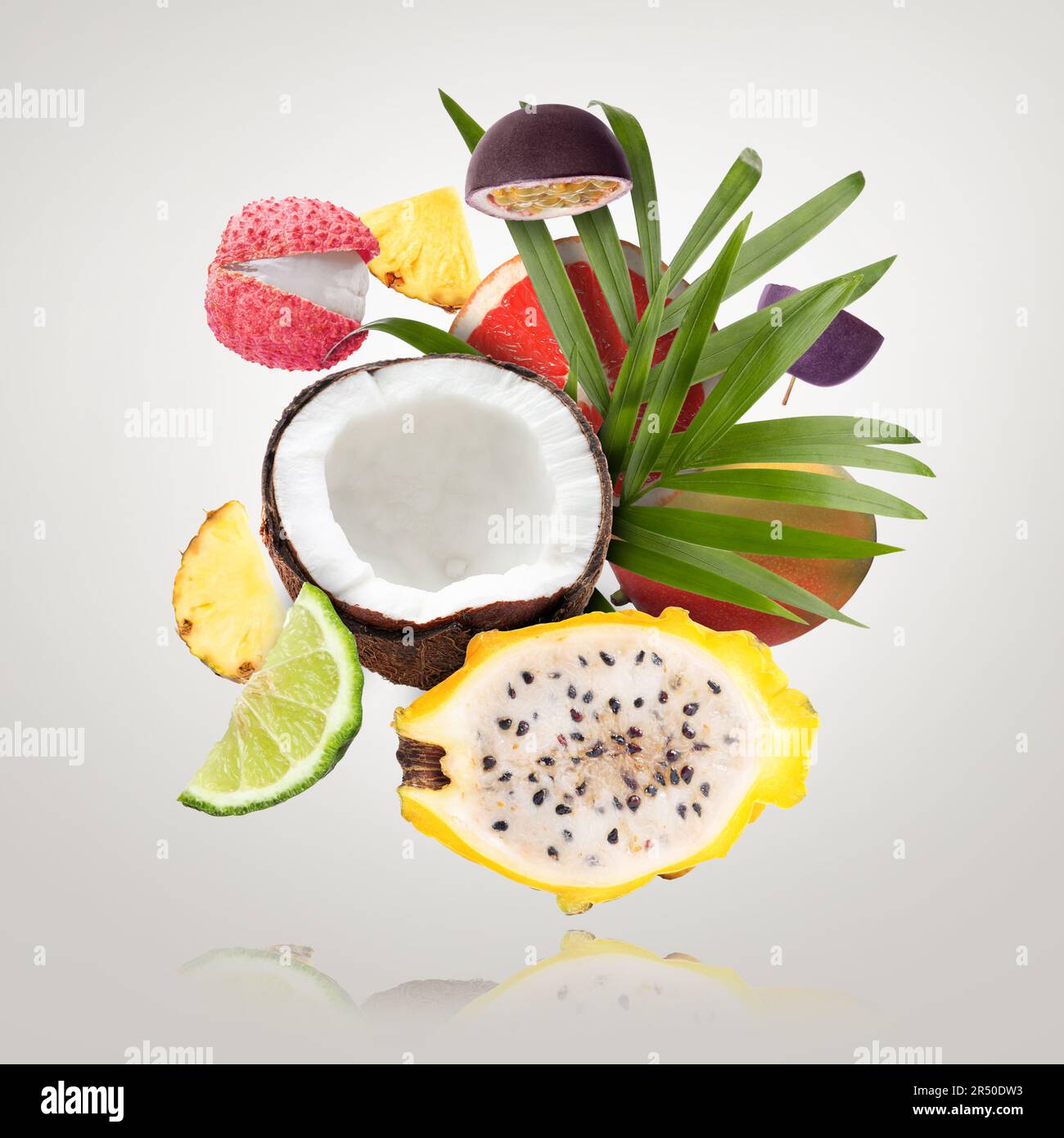Many fresh tropical fruits falling on light background Stock Photo - Alamy