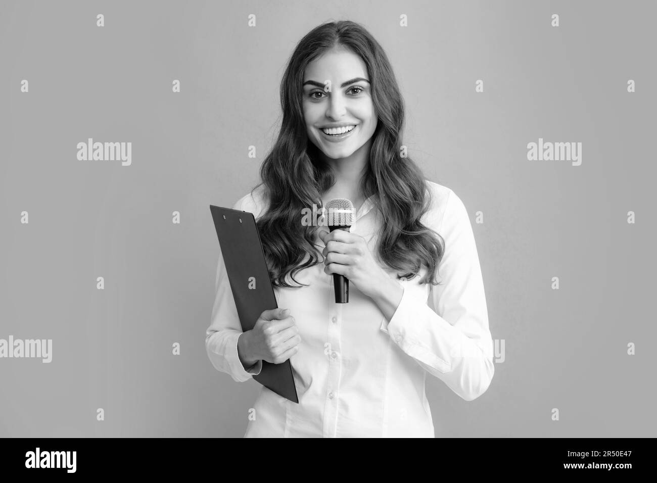 Young business woman talking with mic. Woman talking with microphone ...