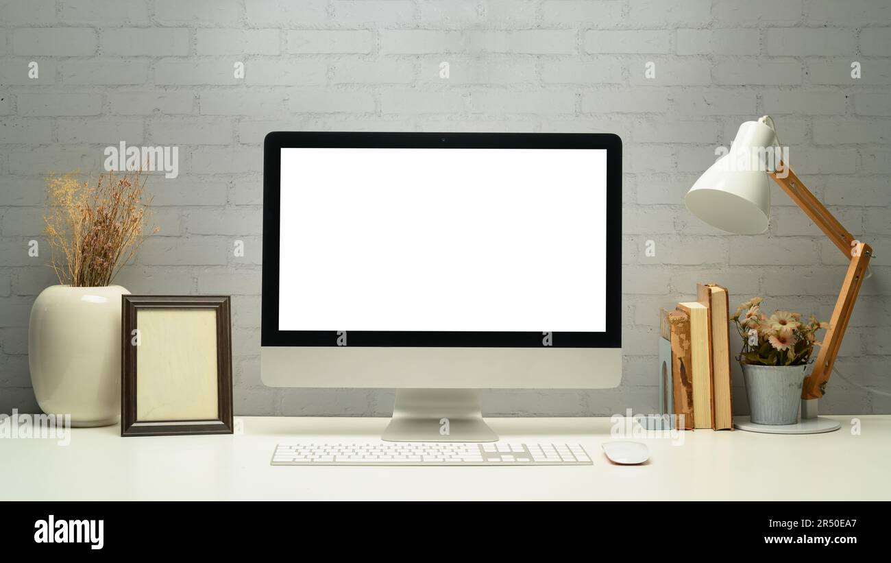 How office desk with blank screen computer, picture frame and books ...