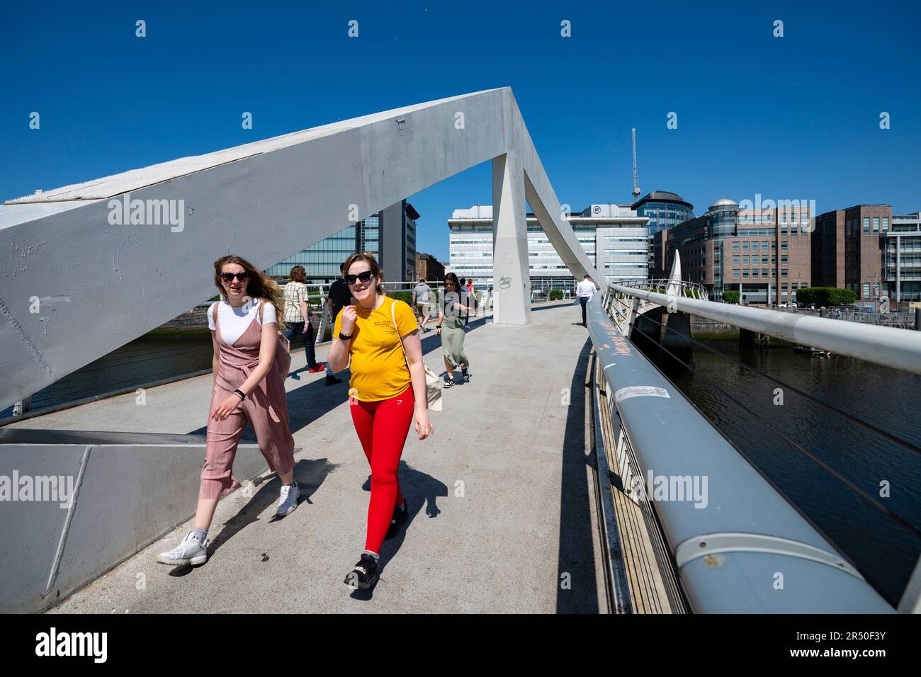 View of pedestrians crossing Tradeston Bridge or Squiggly bridge at ...