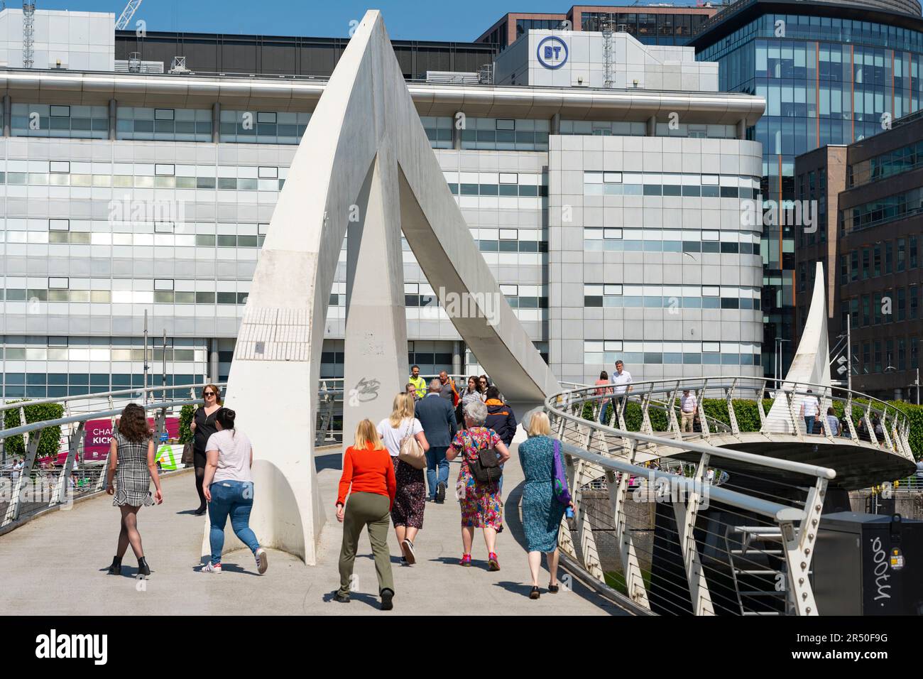 View of pedestrians crossing Tradeston Bridge or Squiggly bridge at ...