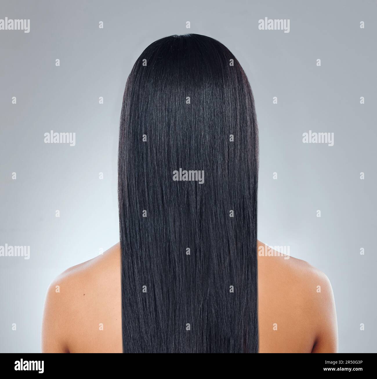 Hair care, back of woman with straight hairstyle and studio backdrop ...