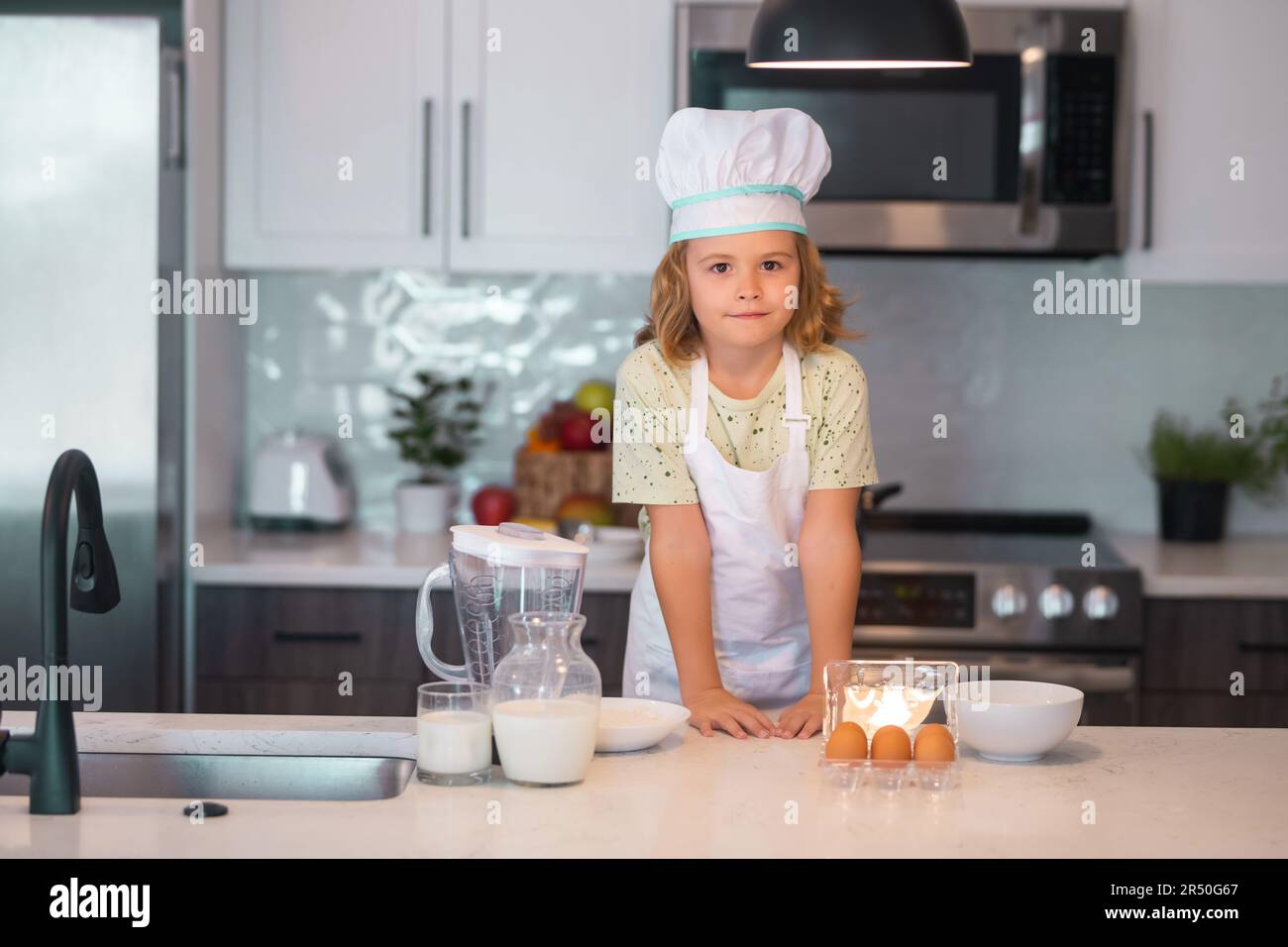Kid chef cook cookery at kitchen. Portrait of little child in uniform ...