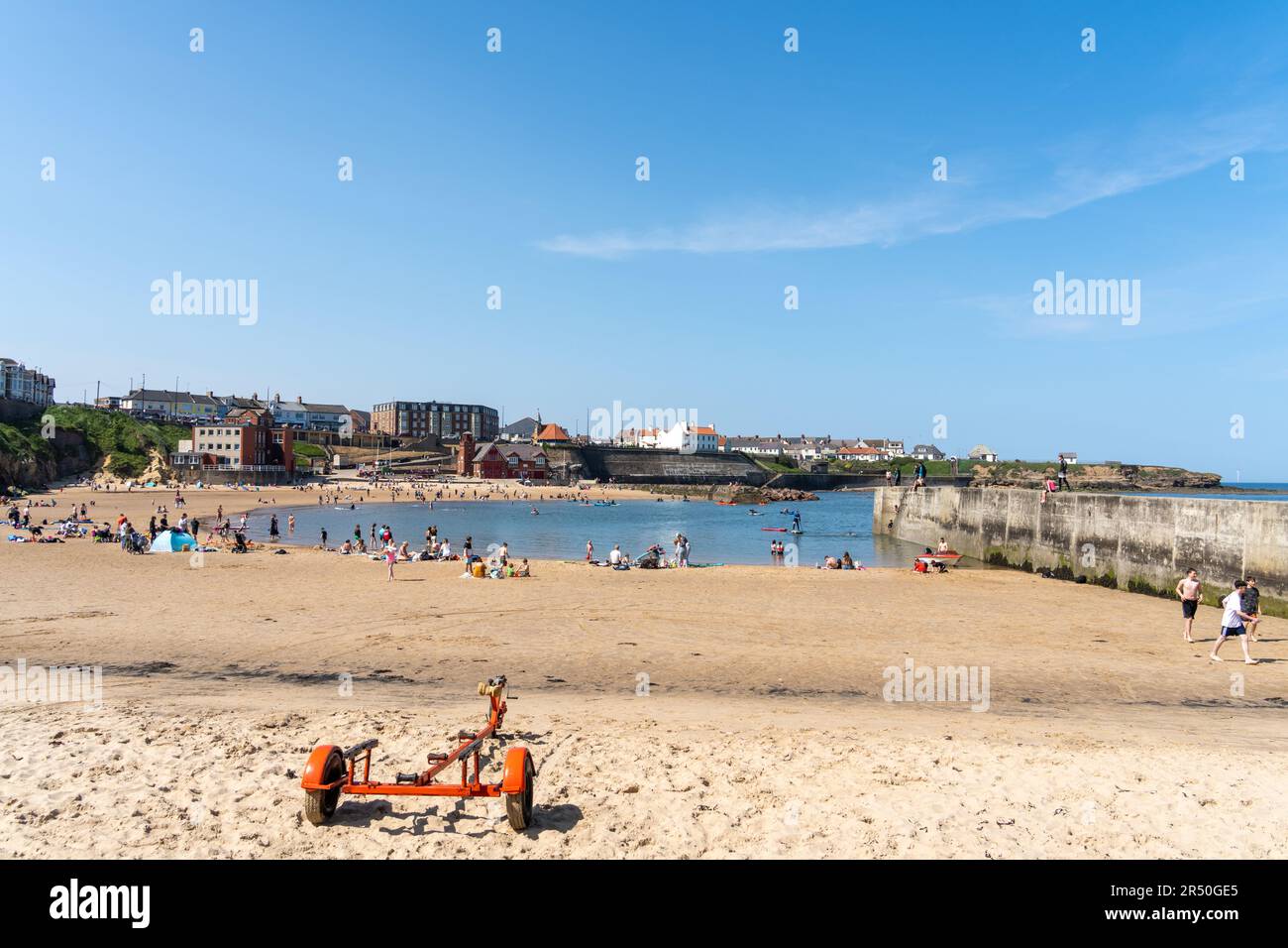 People enjoying the sunny weather at the coast. Cullercoats Bay, North ...