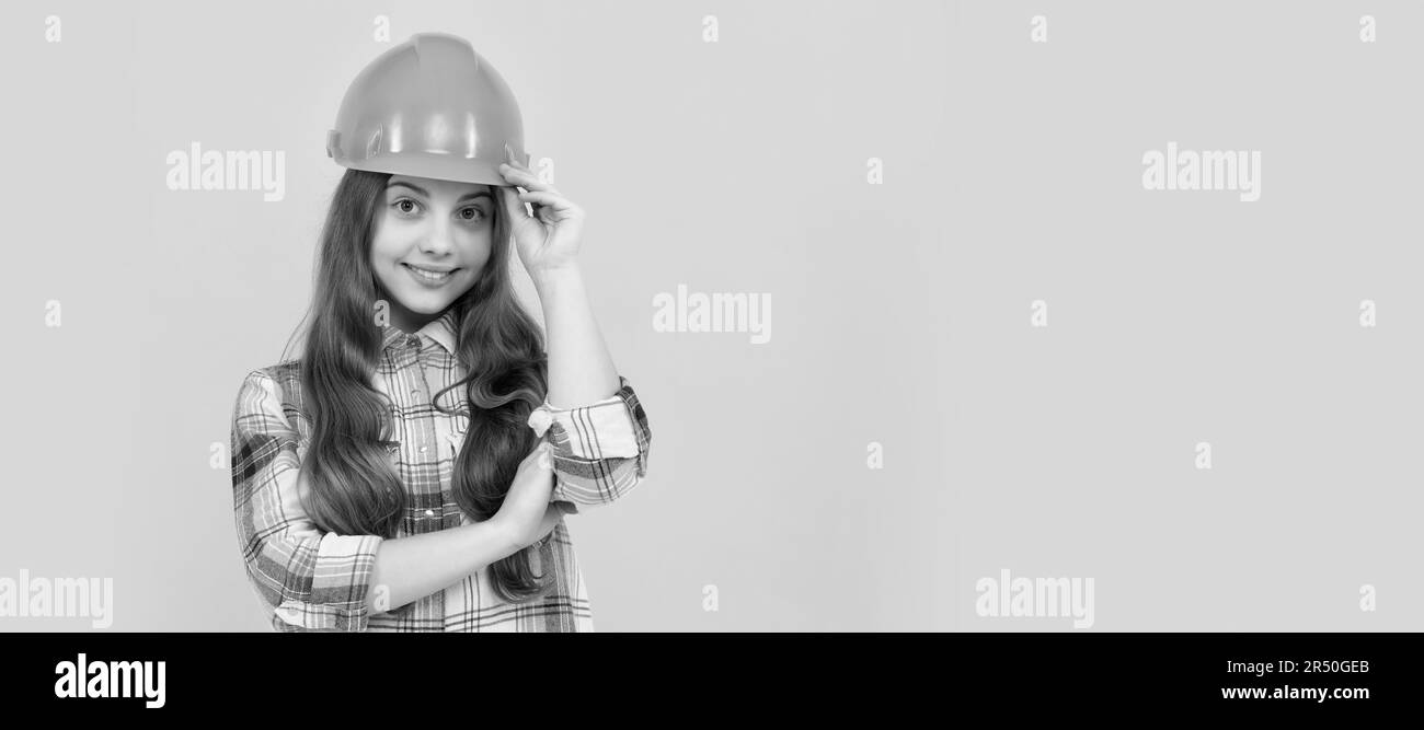 Renovation child, happy teen girl in helmet and checkered shirt ...