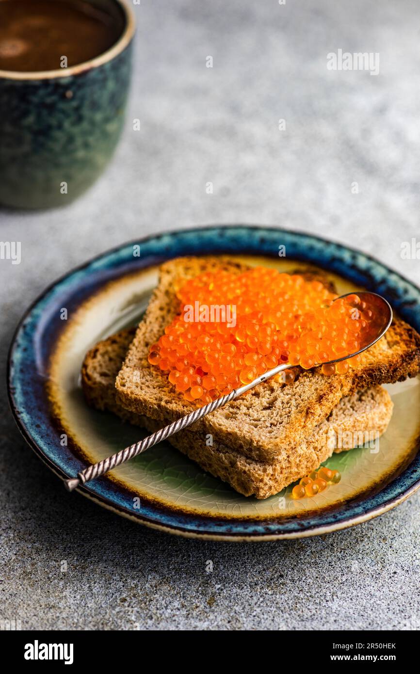 Red trout caviar on the whole wheat toast bread as a healthy food ...