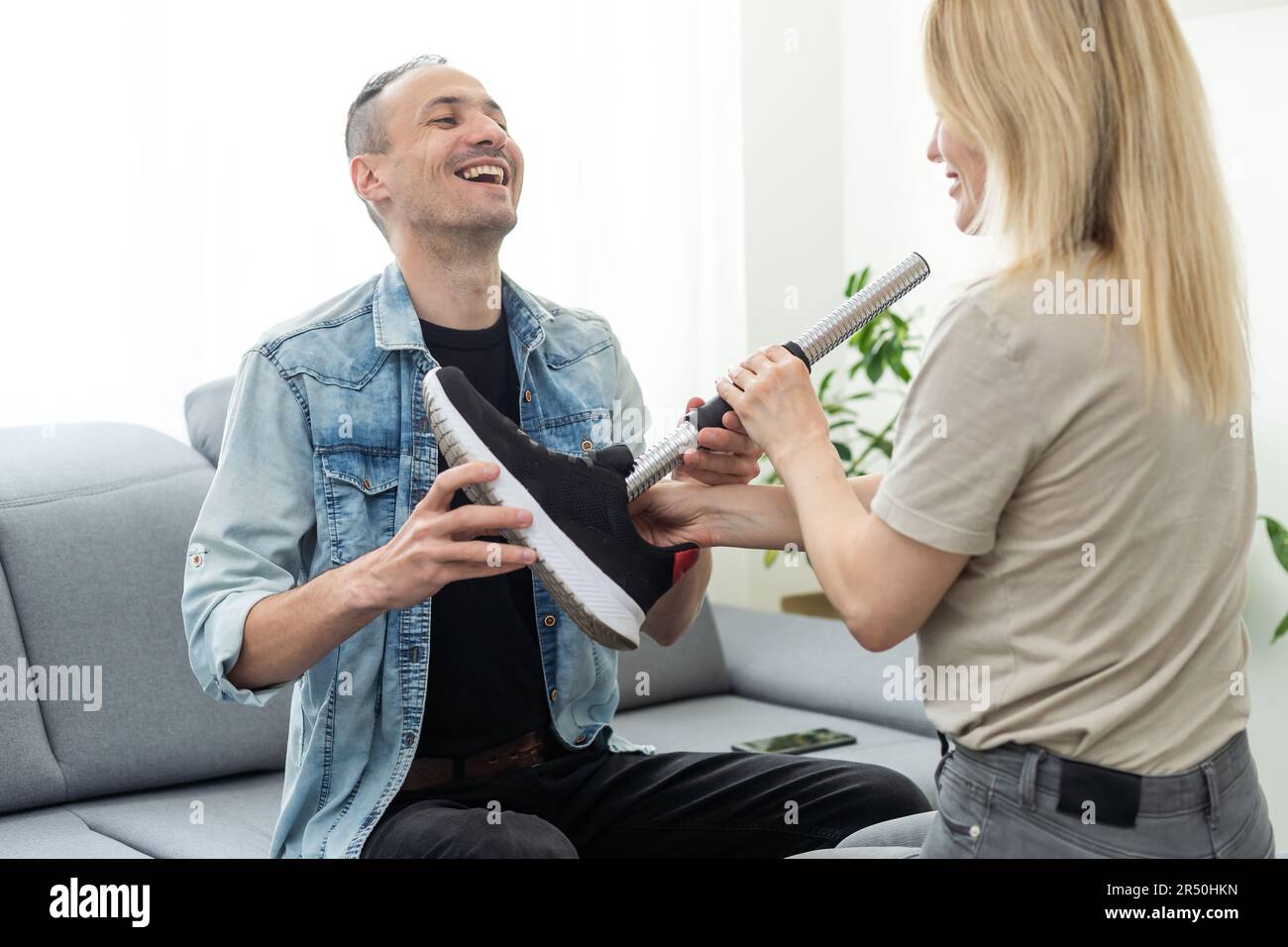 Female technician assembling and fixing parts of modern prosthetic leg ...