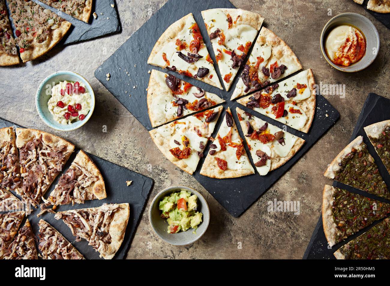 A selection of pizzas on slate platters Stock Photo - Alamy