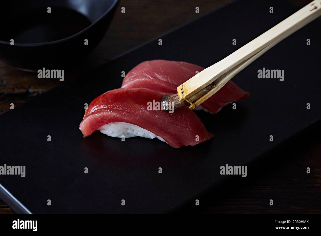 Sashimi being brushed with oil Stock Photo - Alamy