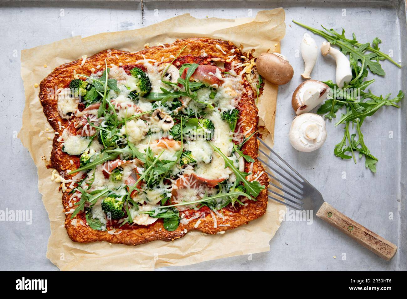 Curd dough (flatbread) pizza with mushrooms and rocket salad Stock ...