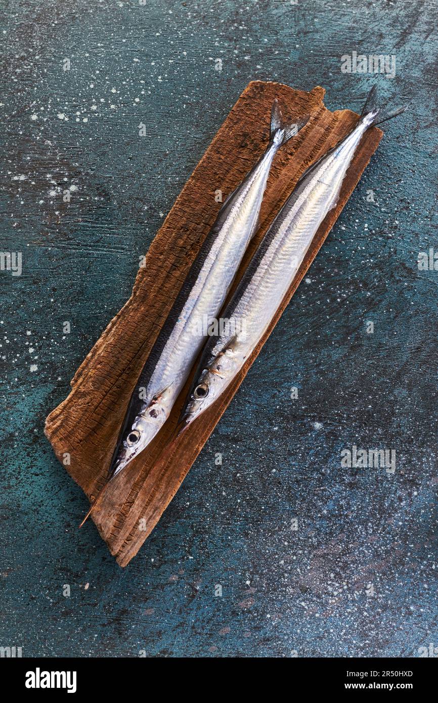 Wooden board with two fresh pike on a concrete background Stock Photo ...