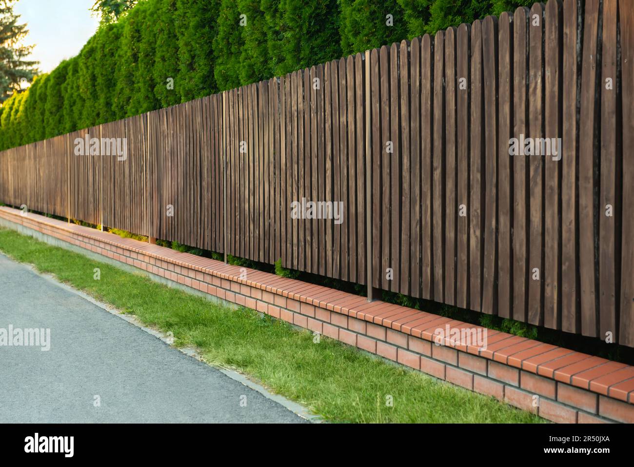 Green trees behind beautiful wooden fence outdoors Stock Photo - Alamy