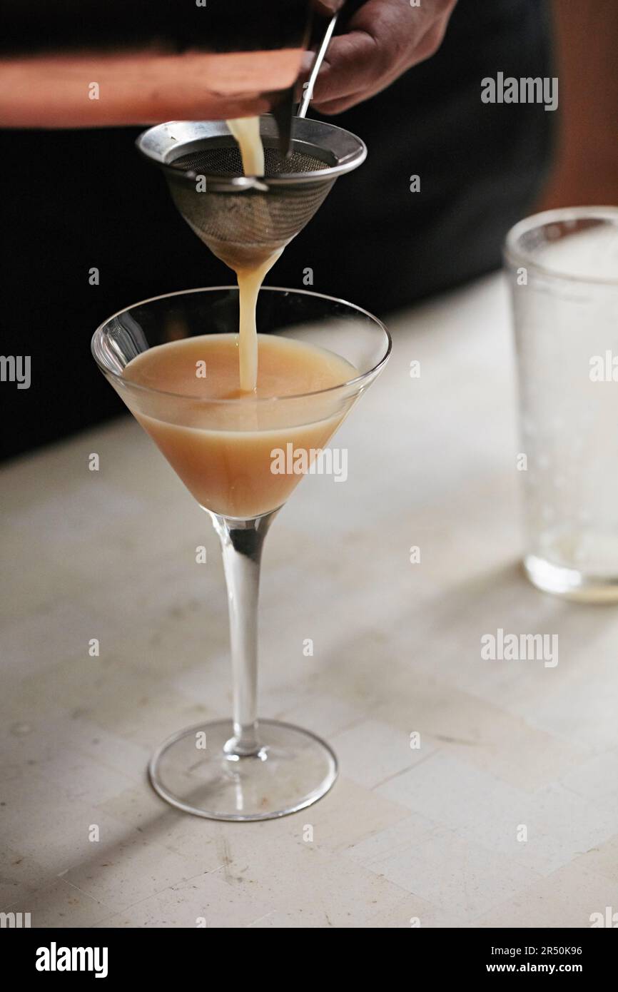 A whisky sour cocktail being poured Stock Photo - Alamy