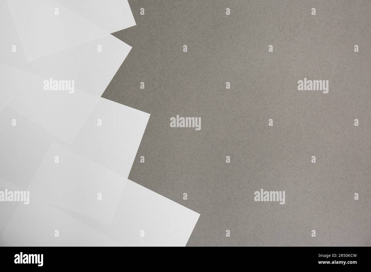 Blank white paper sheets on grey background, flat lay. Space for text ...