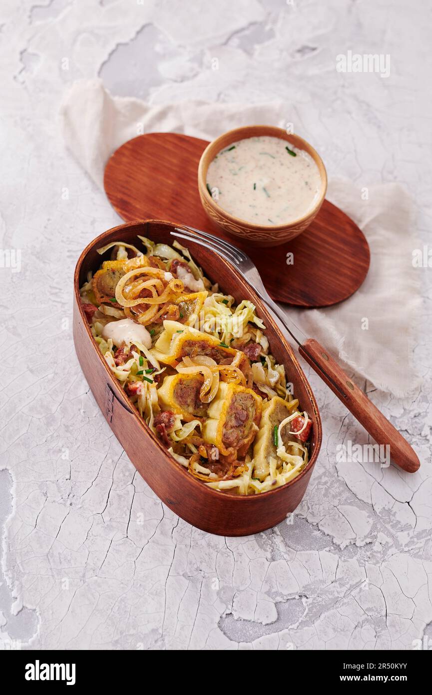 Fried shanks on cabbage salad with sun-dried tomatoes Stock Photo - Alamy
