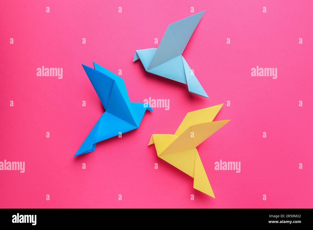 Beautiful colorful origami birds on pink background, flat lay Stock ...