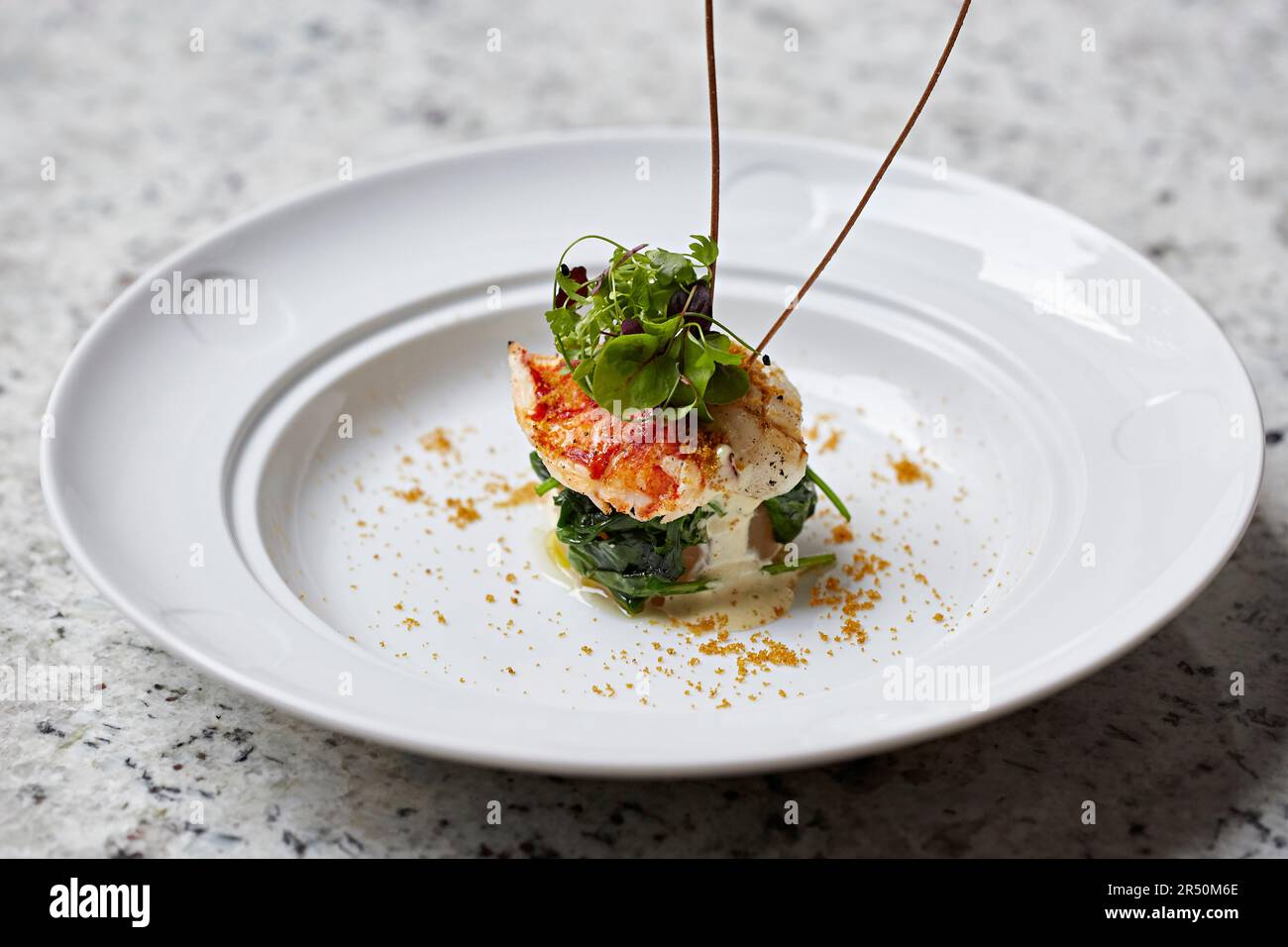 Japanese fine dining seafood dish with spinach Stock Photo - Alamy