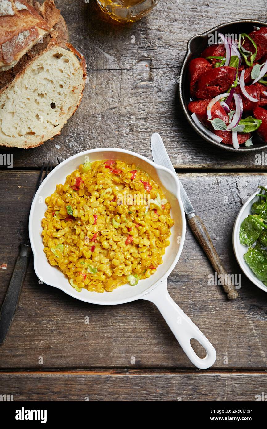 Farro grain dish in a frying pan with chorizo side dish Stock Photo - Alamy