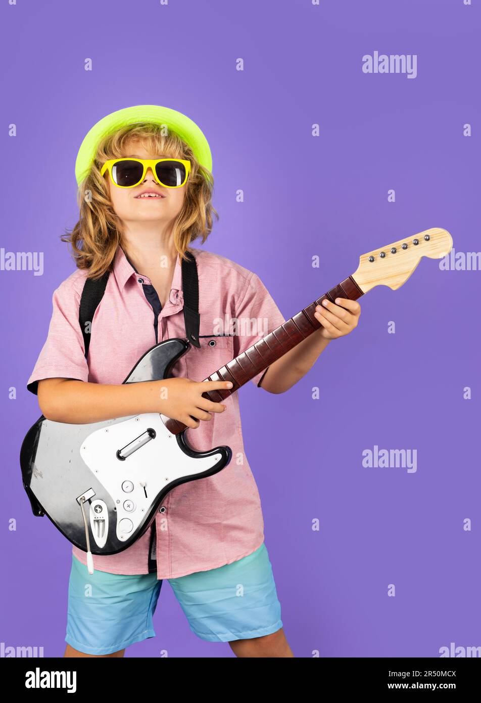 Fashion American country boy playing music. Portrait of cute child boy ...