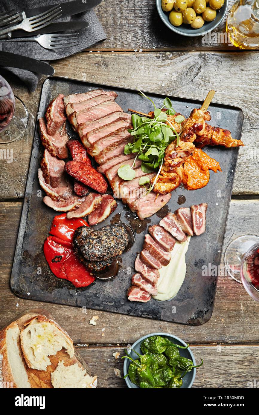 Selection of grilled meats on a metal tray Stock Photo - Alamy