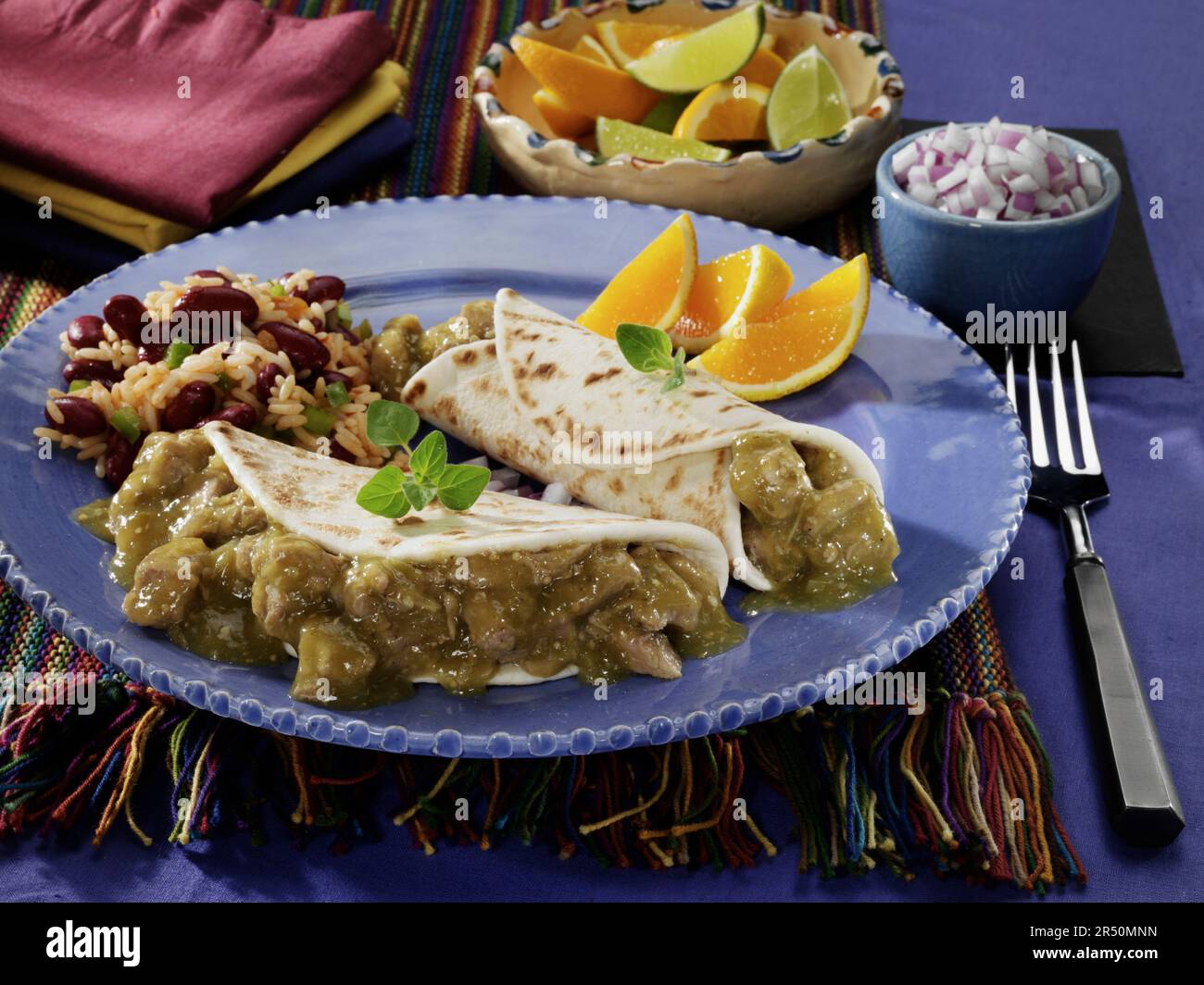 Pork chile verde rolled in flour tortillas with rice and black beans ...
