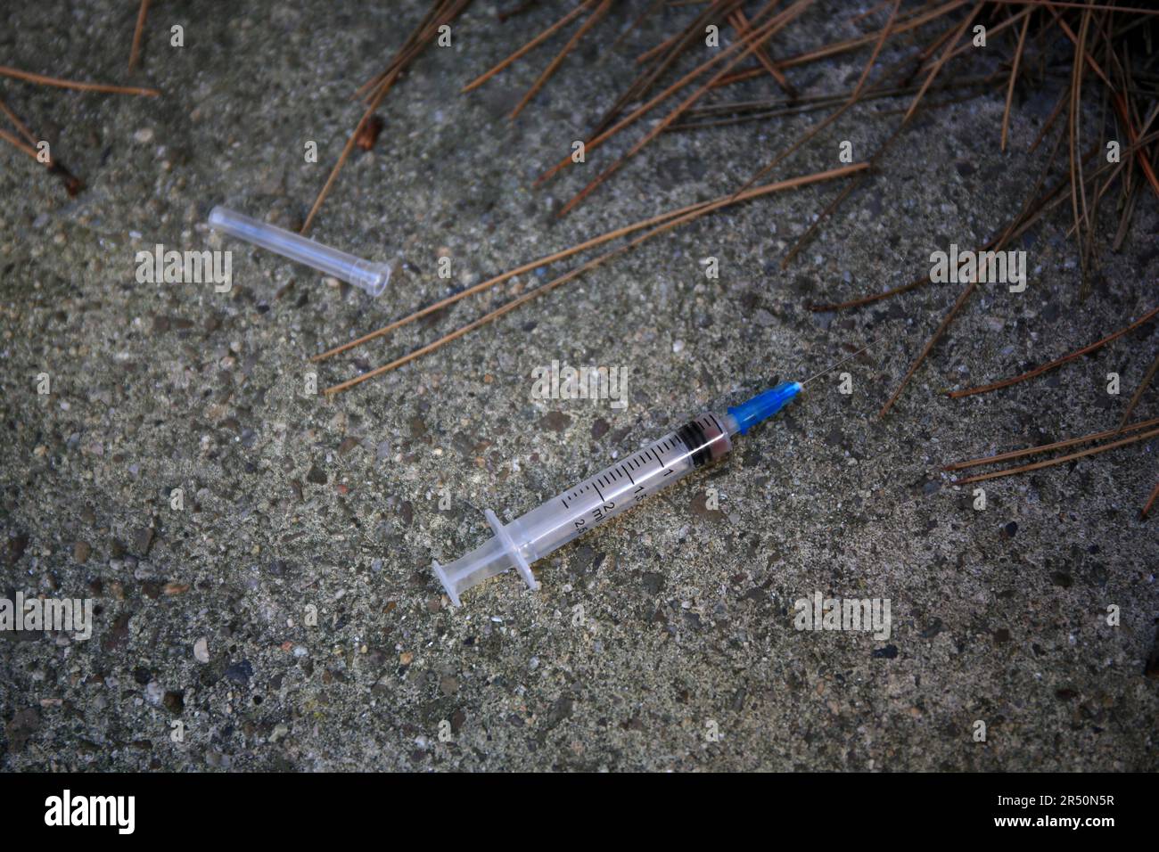 Disposable syringe with needle on stone surface Stock Photo - Alamy