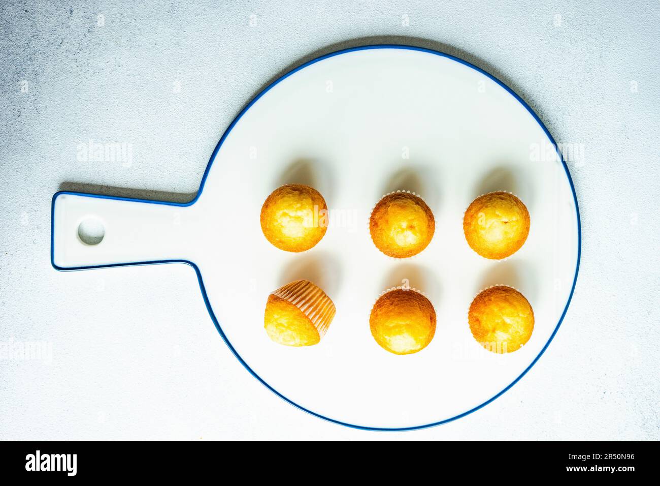 Mini vanilla cupcakes on concrete background Stock Photo - Alamy