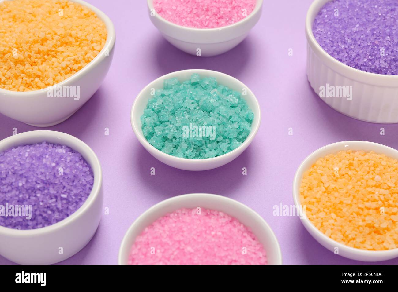 Different types of aromatic sea salt on purple background Stock Photo ...
