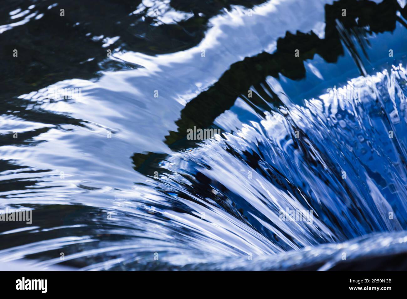 Blue running water surface with abstract reflections pattern. Natural ...